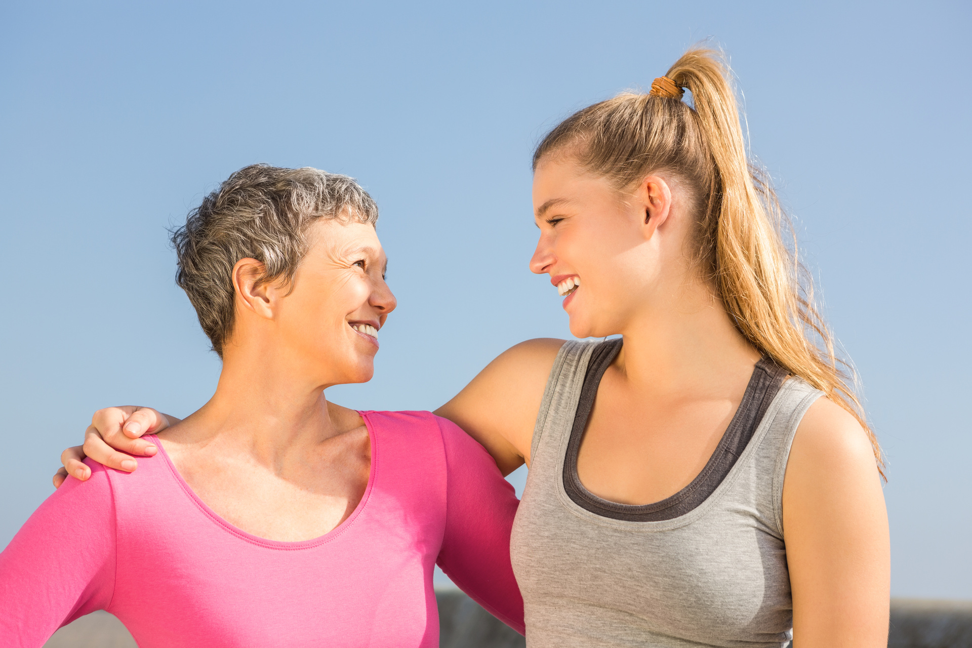 Sporty mother and daughter smiling at each other at promenade – Fit2B ...